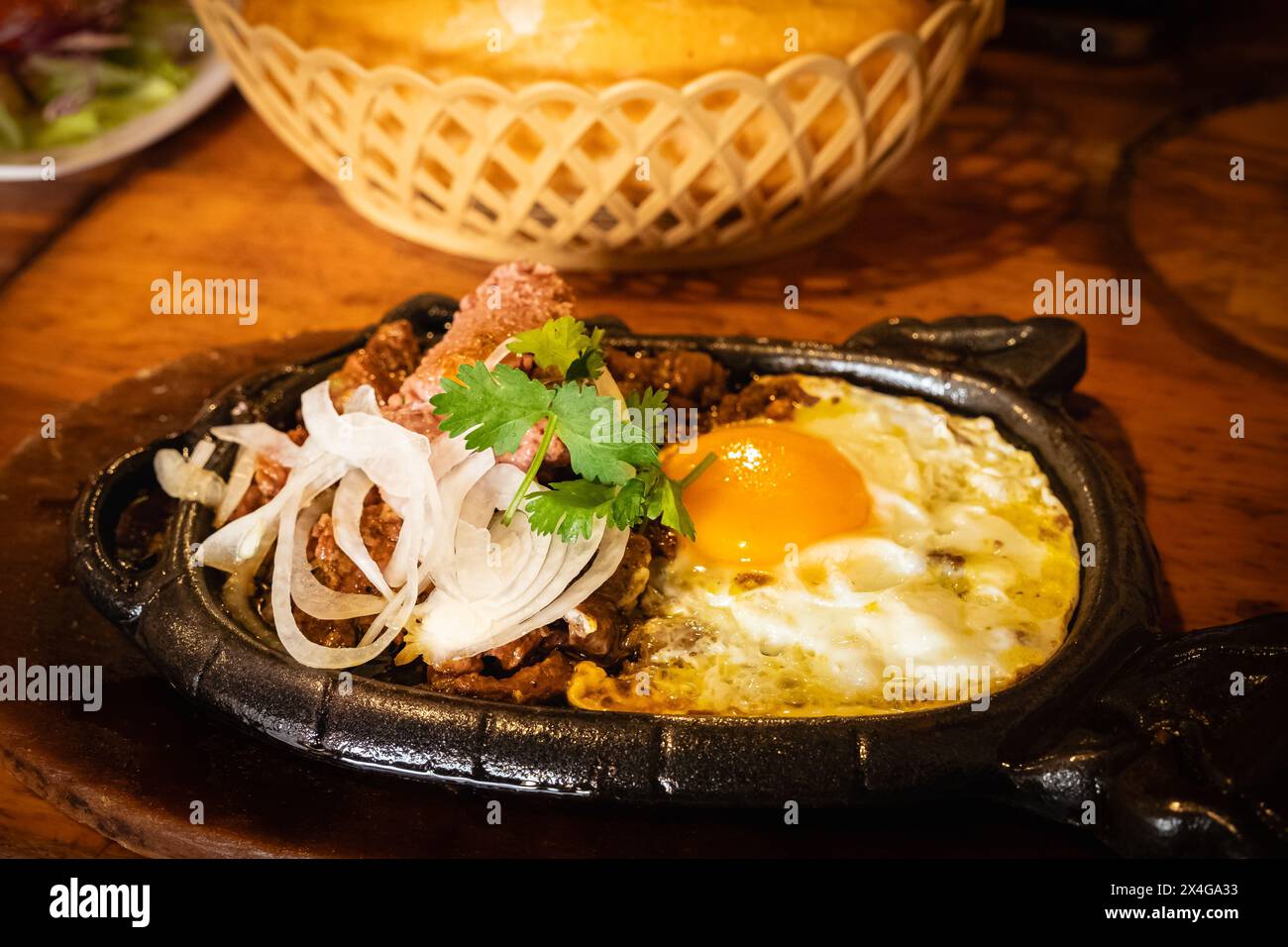 Bo ne trung, beef cooked in a hot plate with gravy and eggs vietnamese ...
