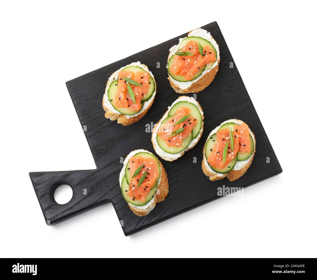 Tasty canapes with salmon, cucumber and cream cheese isolated on white ...