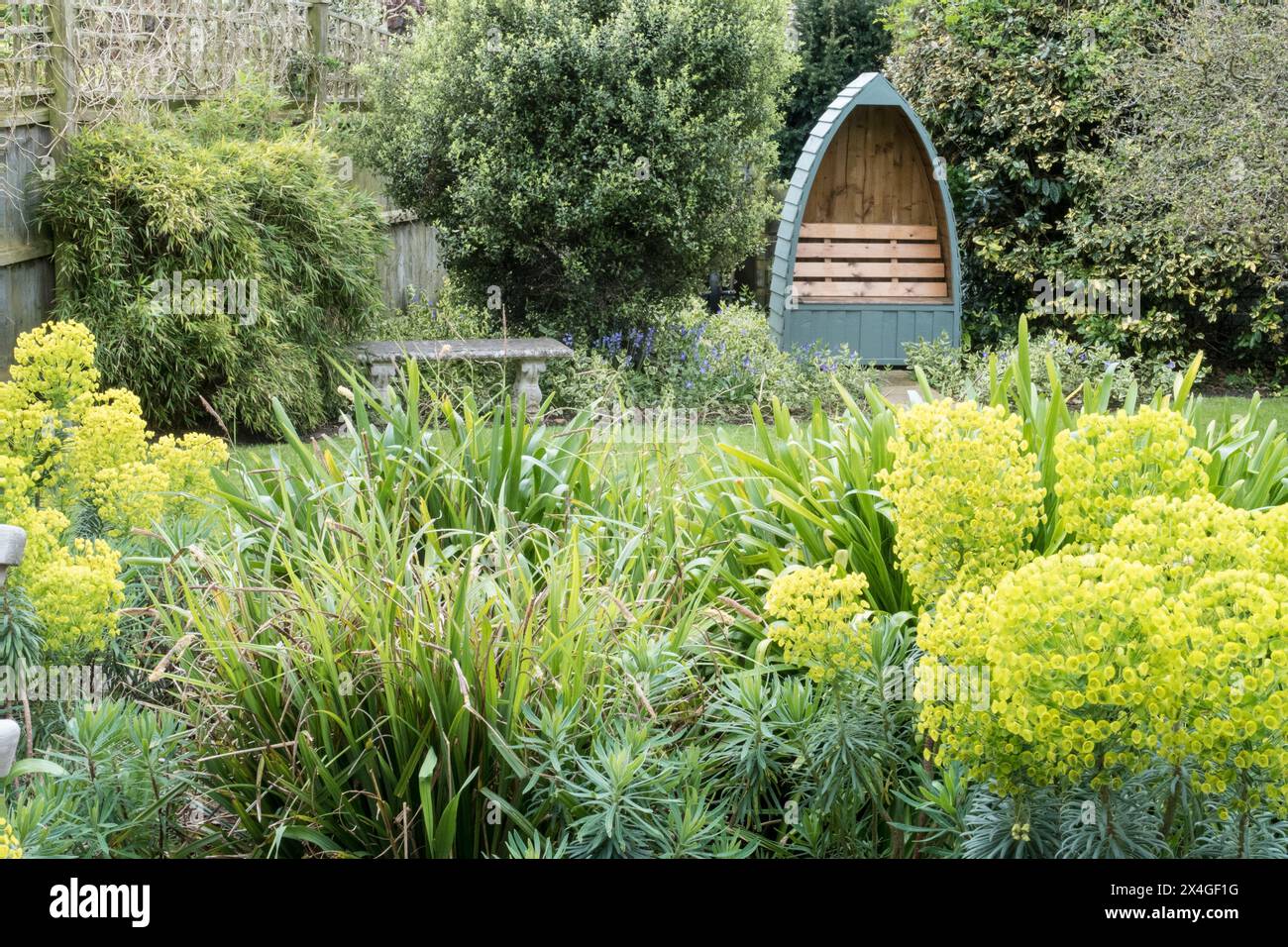 Old English Garden in April with secluded bench Stock Photo - Alamy
