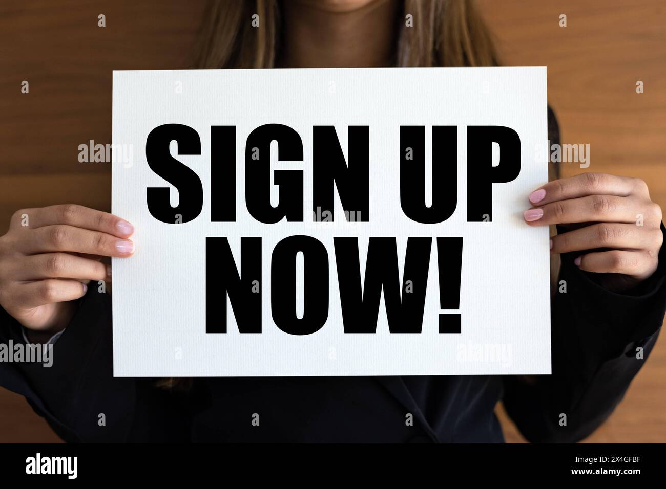 Sign up Now Sign up now Woman with white page, black letters ...