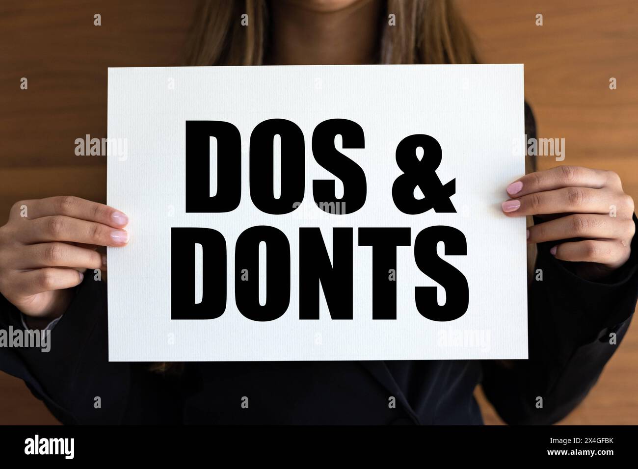 Dos and Donts. Dos and Donts. Woman with white page, black letters ...