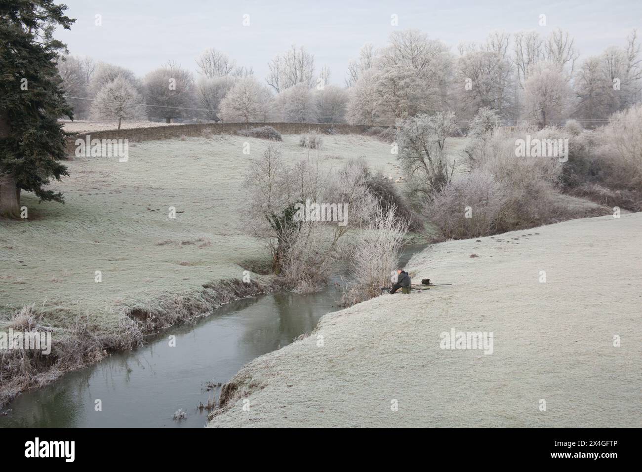 A man fishing in the River Evenlode at Cornbury Park, Charlbury ...