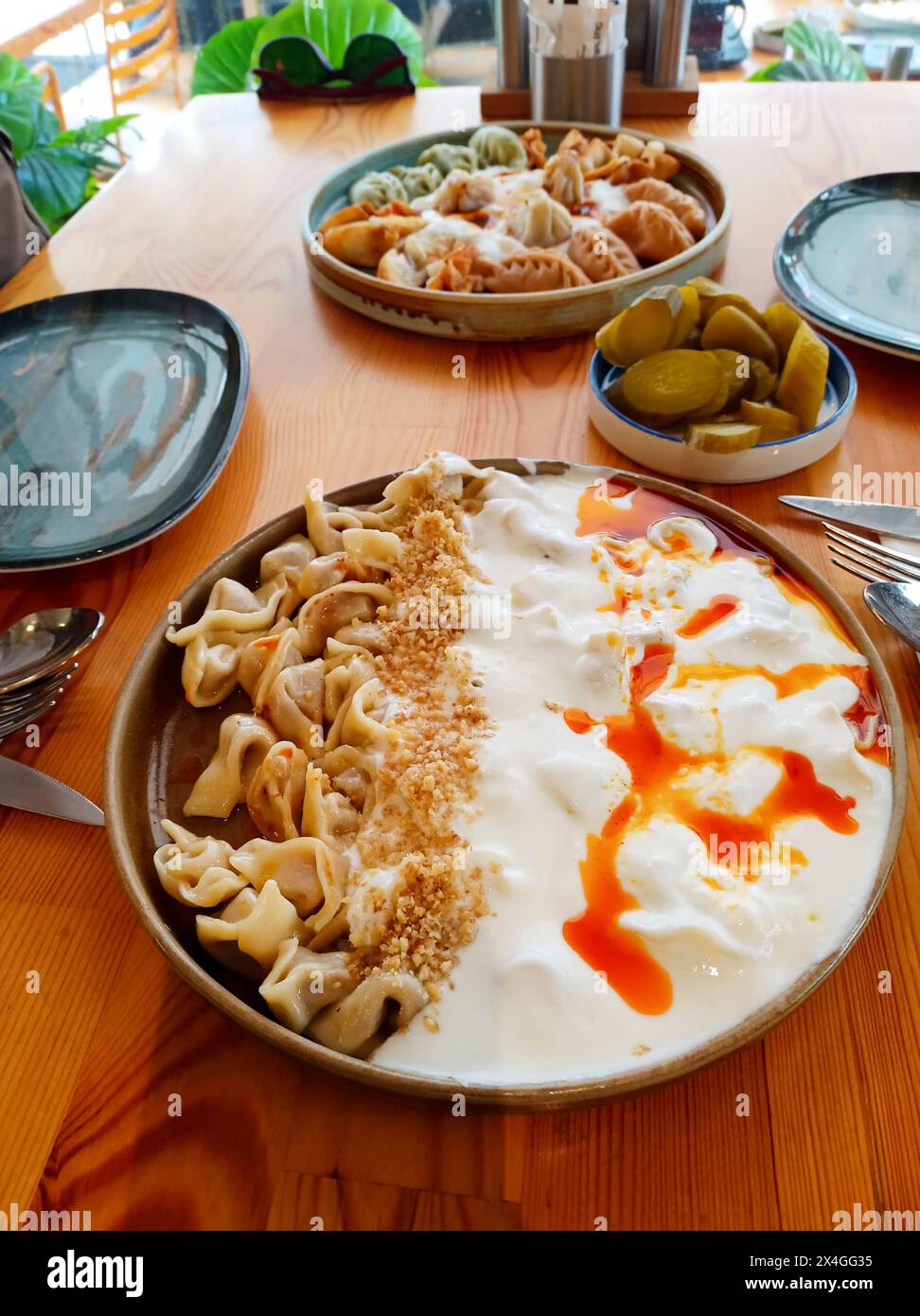 Turkish ravioli in a dish at a restaurant, serves with yogurt and ...
