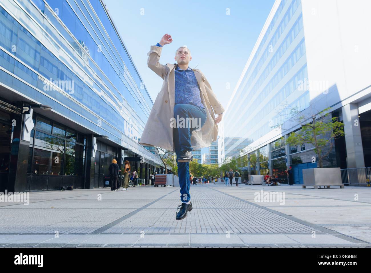 Entrepreneurial short-haired young blond man in blue casual clothes ...