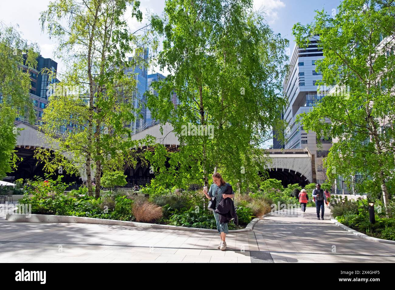 People walking in Exchange Square garden park near Liverpool Street ...