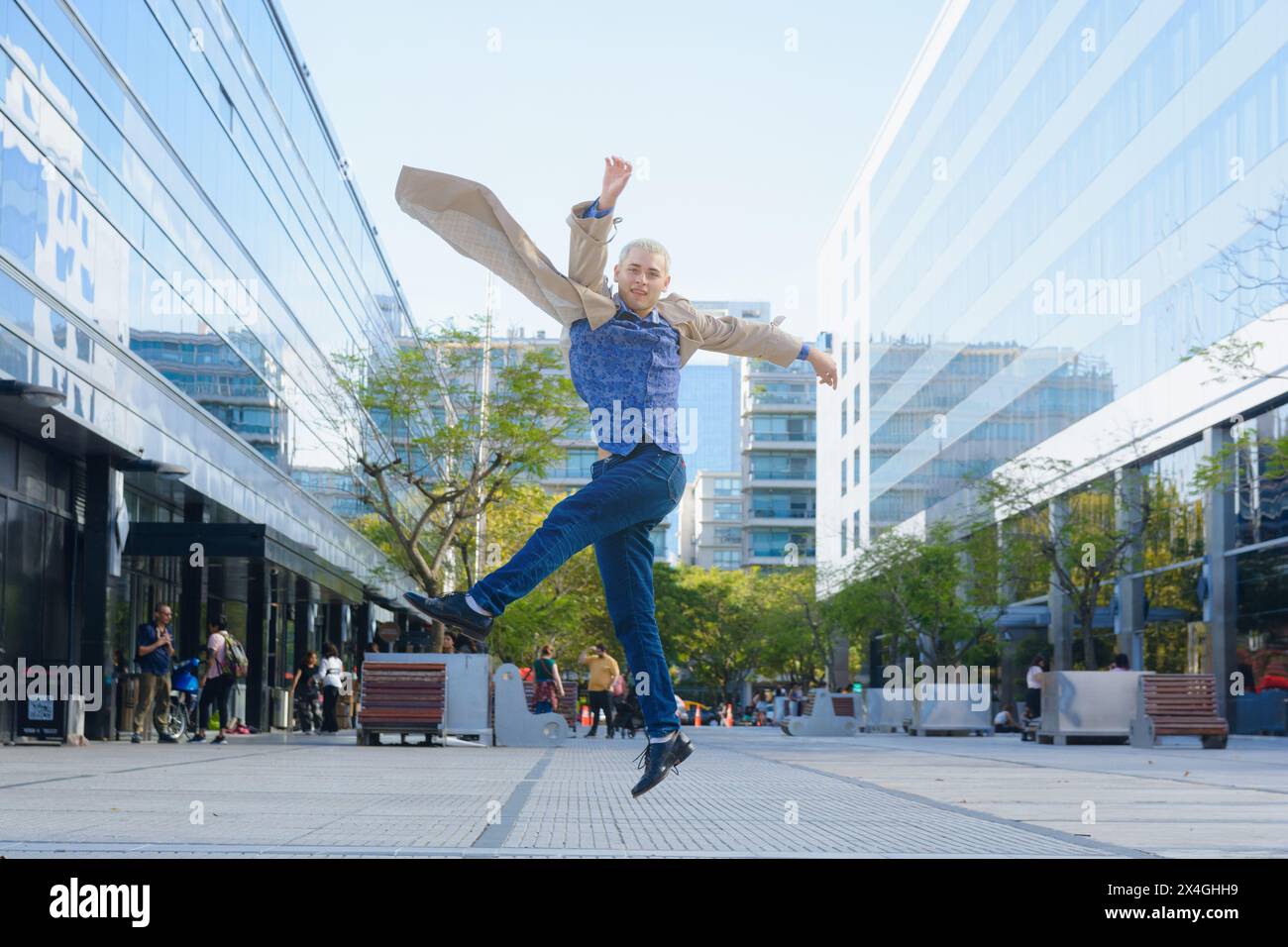 Entrepreneurial short-haired young blond man in blue casual clothes ...