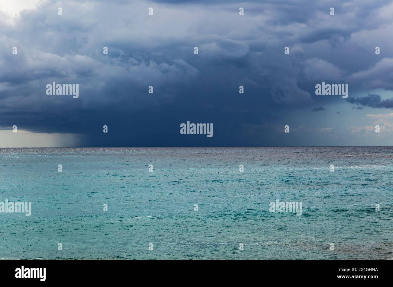 Heavy rain falling dark storm cloud above Ionian Sea, offshore from ...