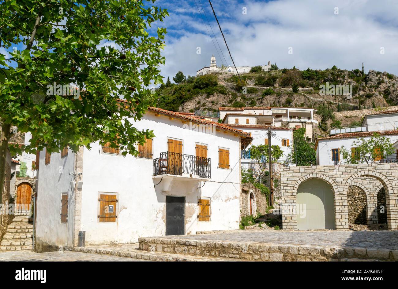 Village houses and hilltop Greek Orthodox church of Saint Mary, or ...