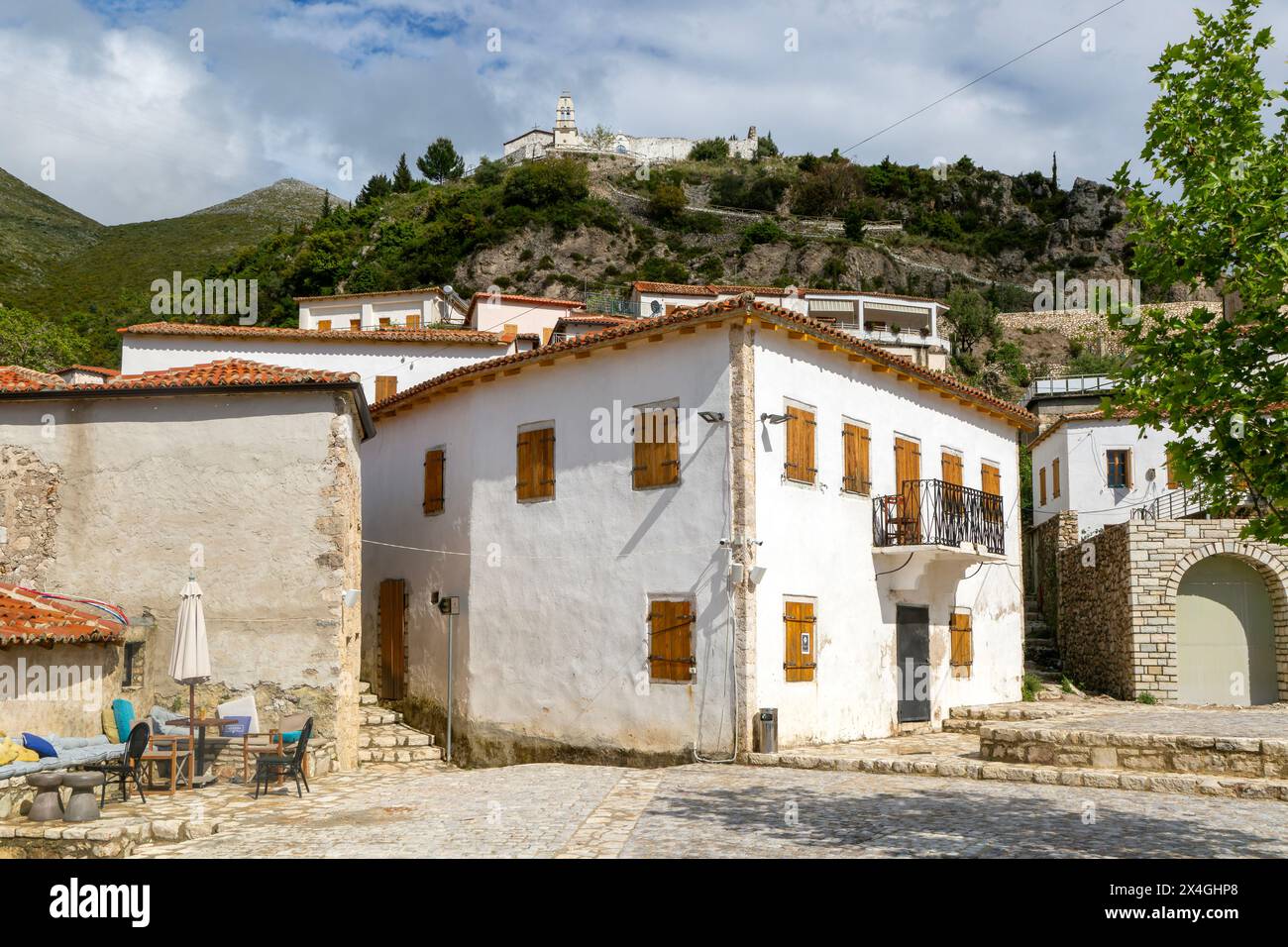 Village houses and hilltop Greek Orthodox church of Saint Mary, or ...