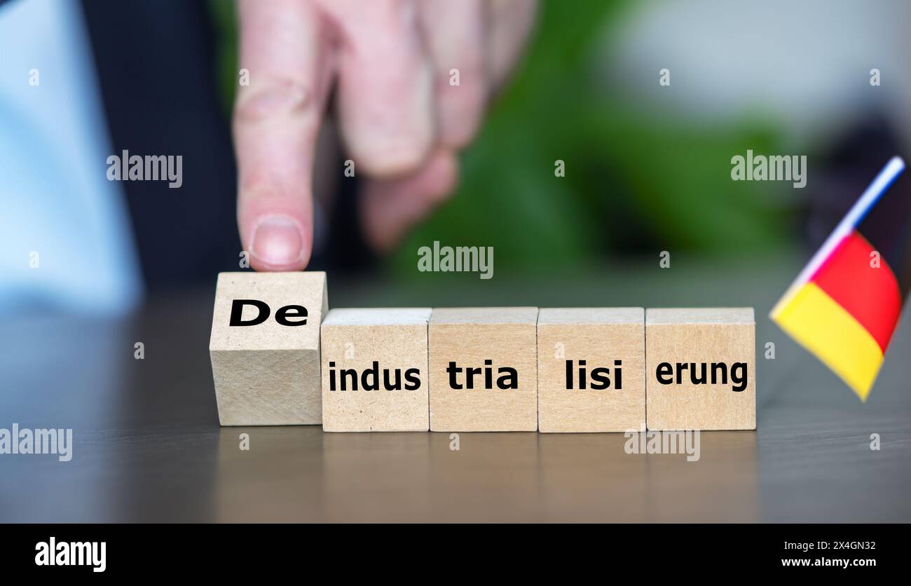 Hand turns wooden cube and changes the German expression ...