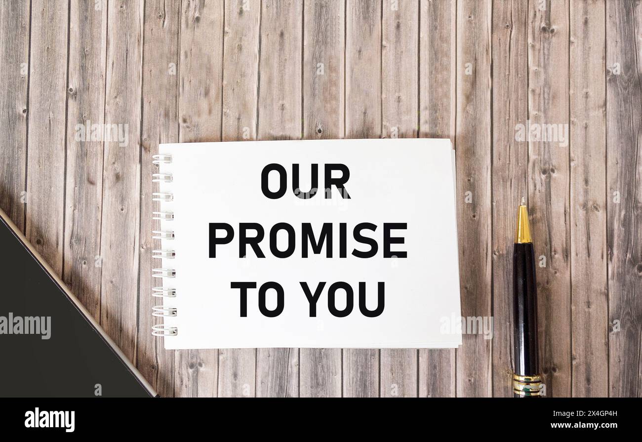 OUR PROMISE TO YOU text on notepad and wooden background Stock Photo ...