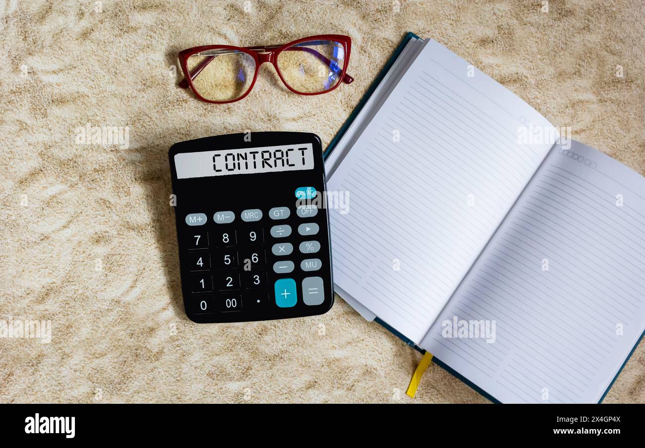 The word contract is written on the display of the calculator, next to ...