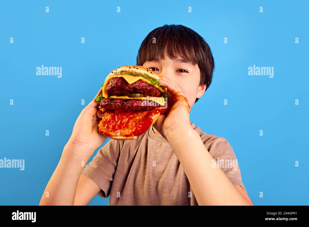 Little boy, kid holding giant, juicy fresh burger with meat, tomato ...