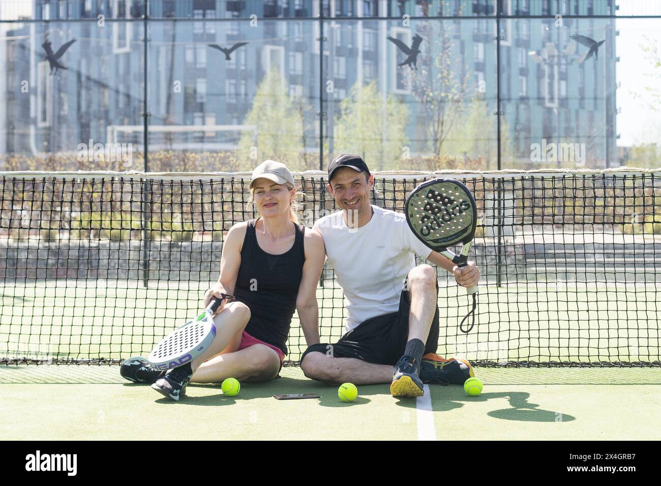 Ukraine Kyiv, April 02 2024. Padel training coach in a session, mentoring a female student ...