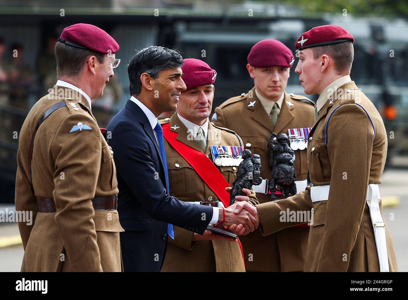 Prime Minister Rishi Sunak presents an award to a member of the ...
