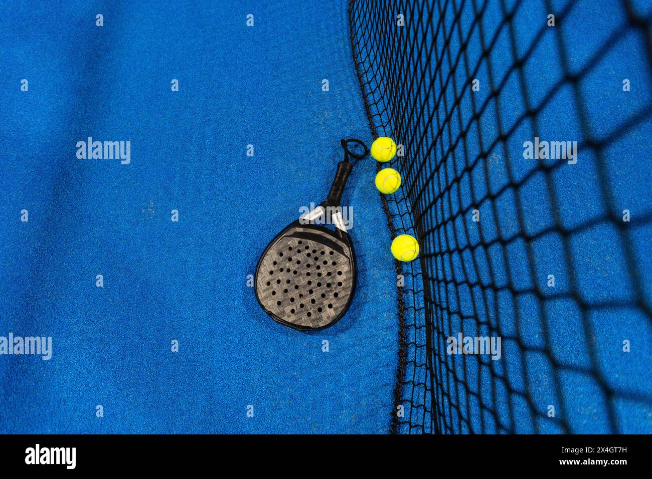 paddle tennis racket and balls on the blue paddle court Stock Photo - Alamy