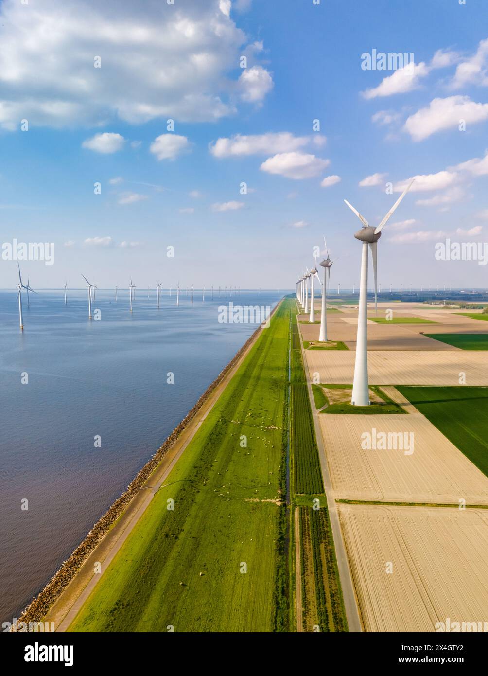 A mesmerizing aerial view of a row of majestic wind turbines spinning ...