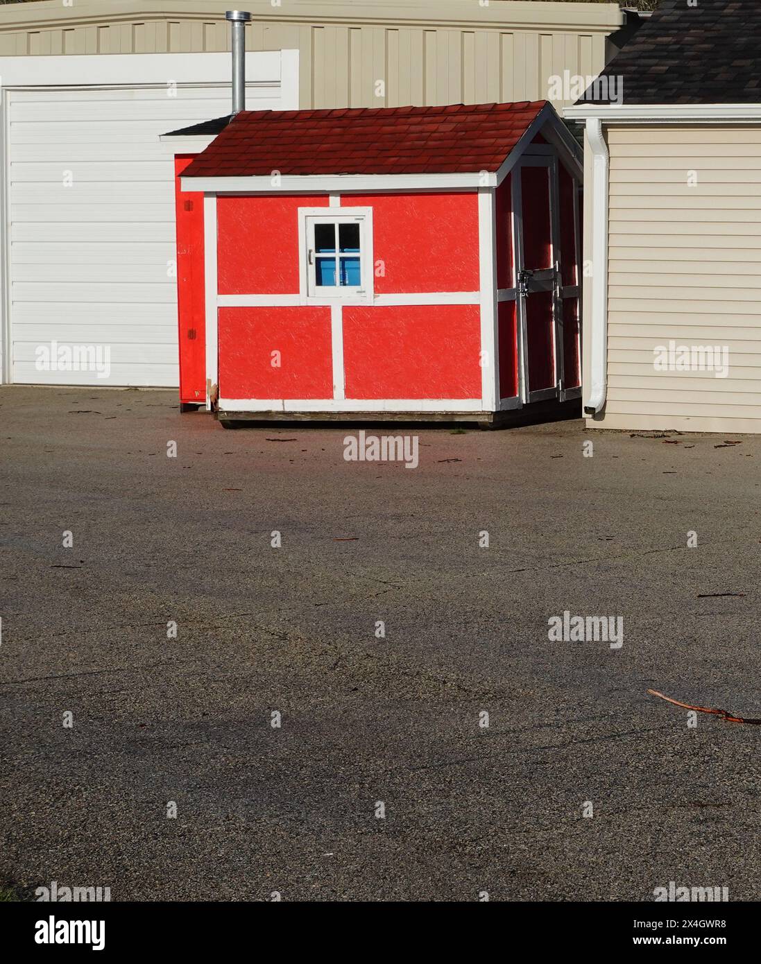 red shed stands out next to beige buildings Stock Photo - Alamy