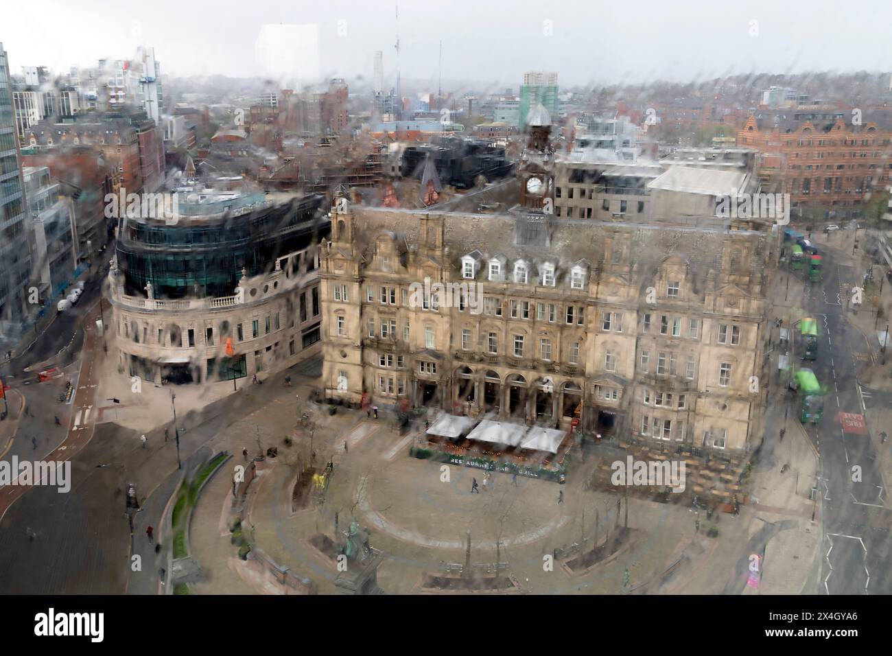 A rainy day in Leeds, West Yorkshire. City Square is seen through a ...