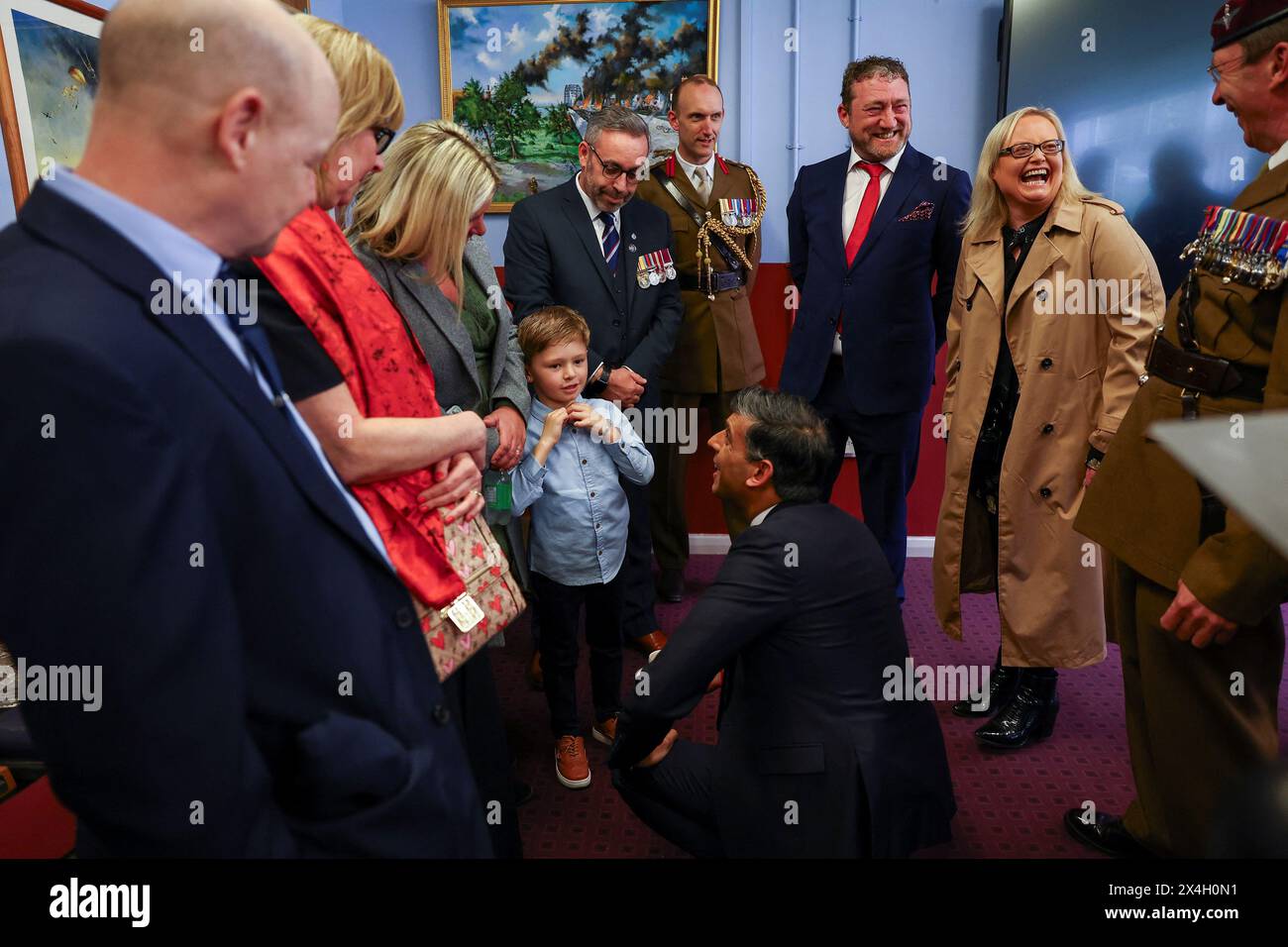 Prime Minister Rishi Sunak speaks with a child as he meets with ...