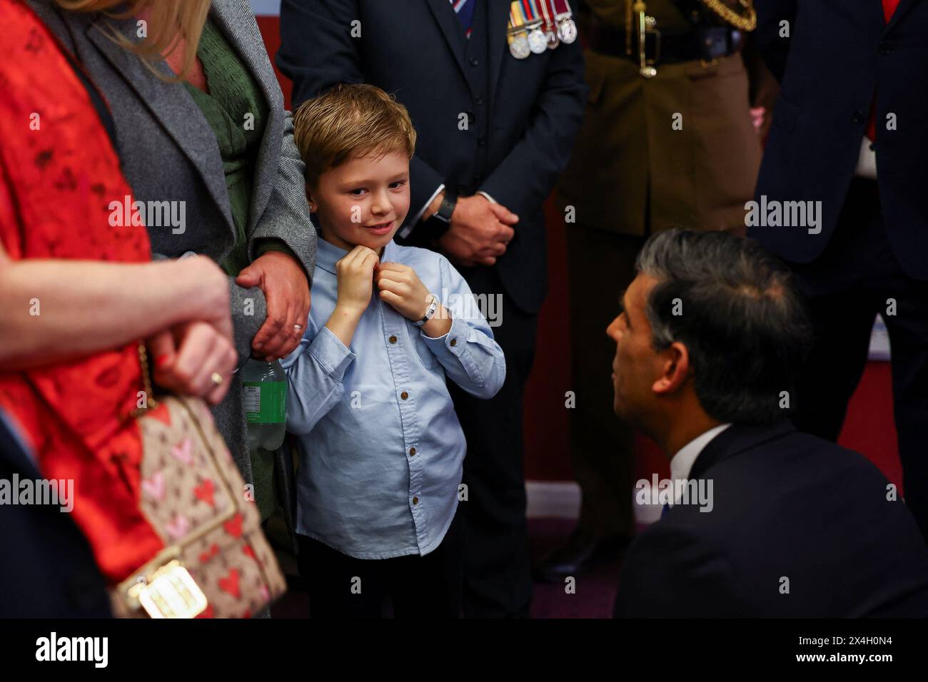 Prime Minister Rishi Sunak speaks with a child as he meets with ...