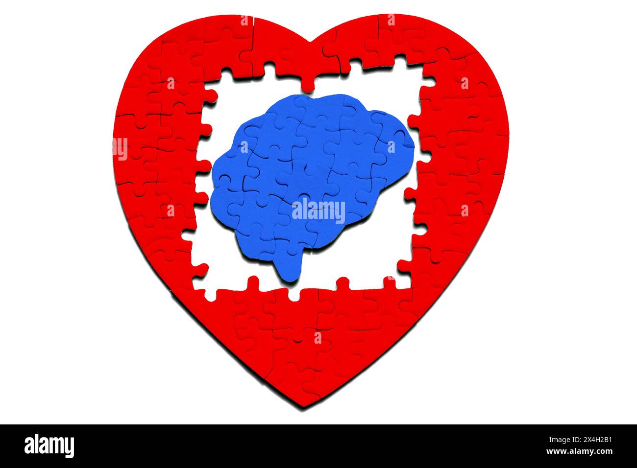 Human brain-shaped puzzle nestled inside a red heart puzzle isolated on ...