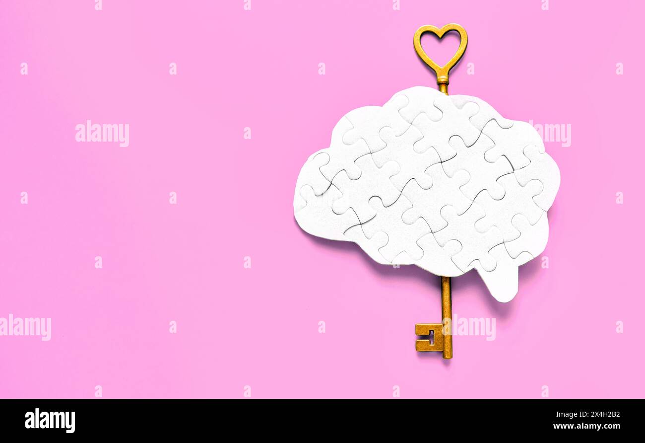Human brain-shaped puzzle paired with a key, symbolizing the unlocking of the mysteries of the ...