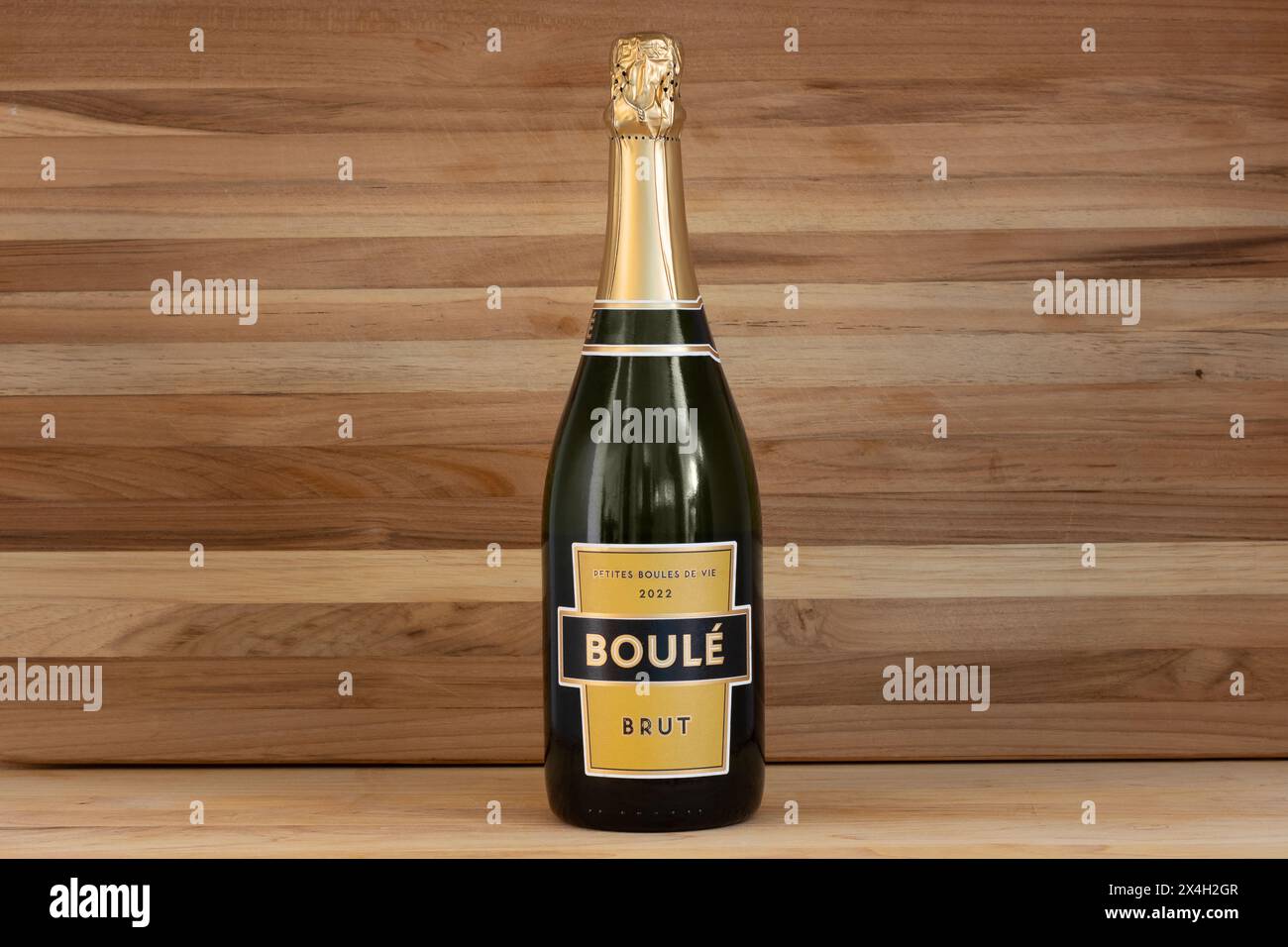 bottle of Boule Brut sparkling wine on a rustic wood background with ...