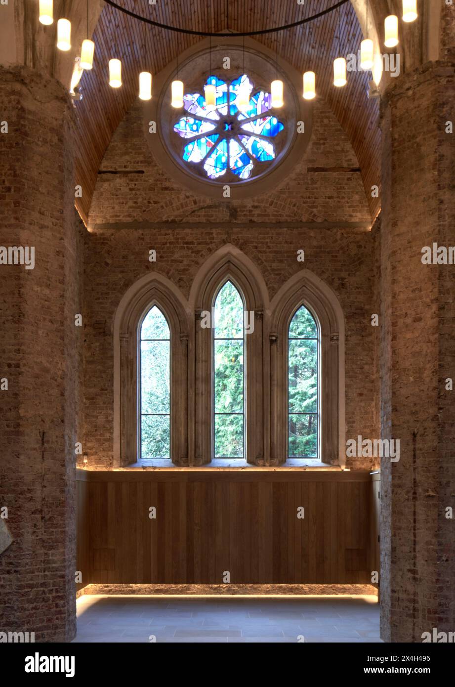 Arched gothic window with view to cemetery. Abney Park Chapel, London ...