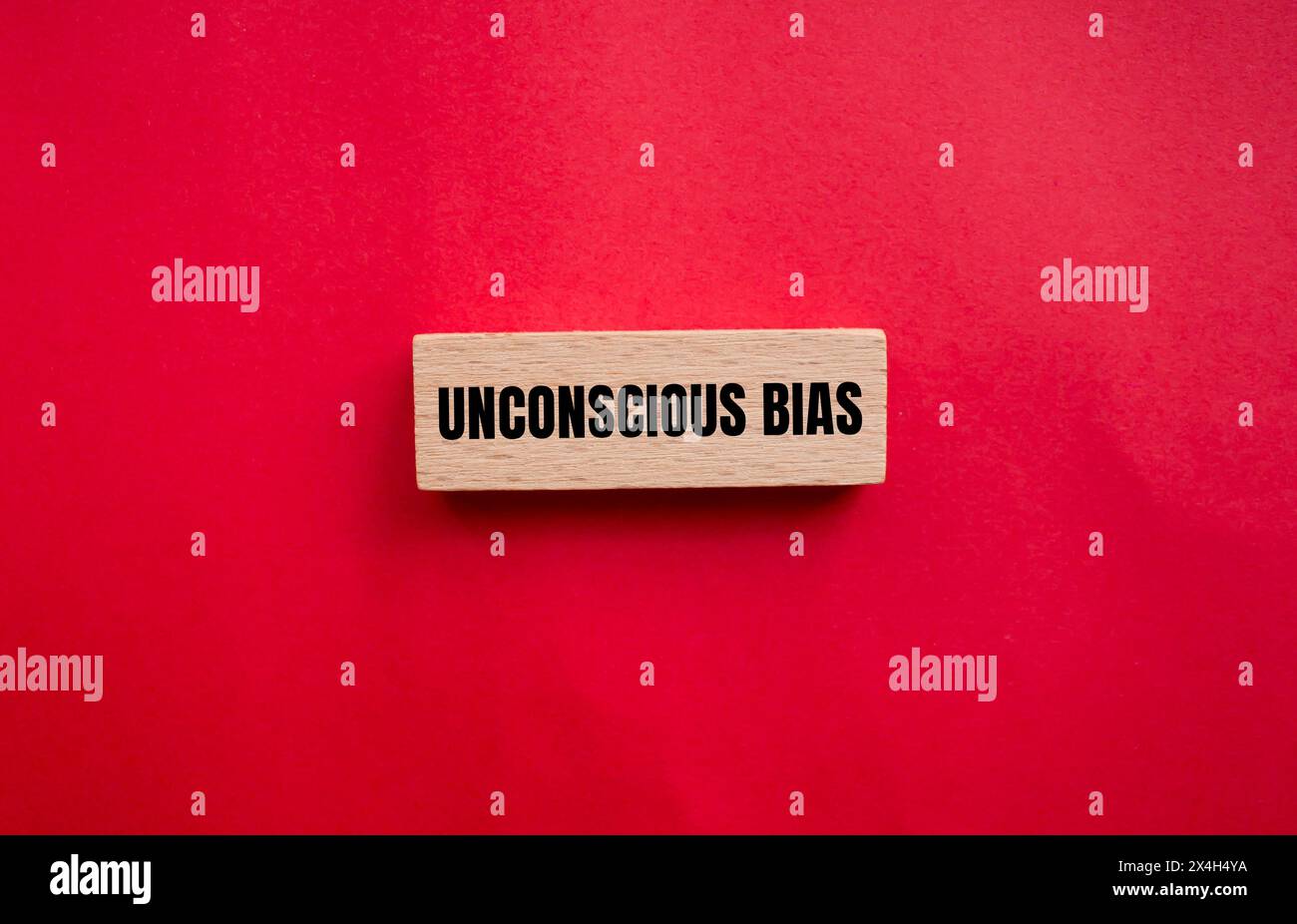 Unconscious Bias Words Written On Wooden Block With Red Background Conceptual Unconscious Bias