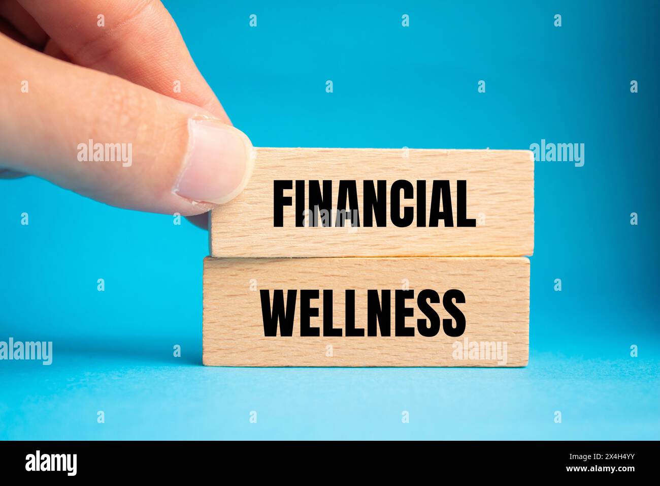 Financial wellness words written on wooden blocks with blue background ...