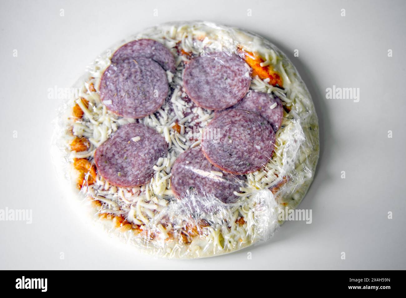 Frozen semi-finished pizza from the supermarket. Fast food concent ...
