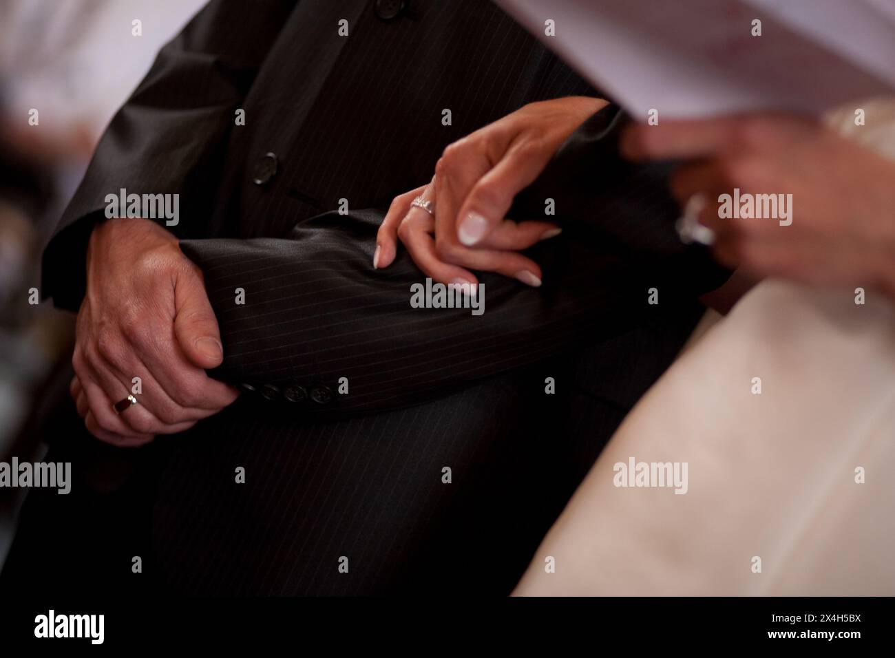 This close-up captures the subtle intimacy of a couple during their ...
