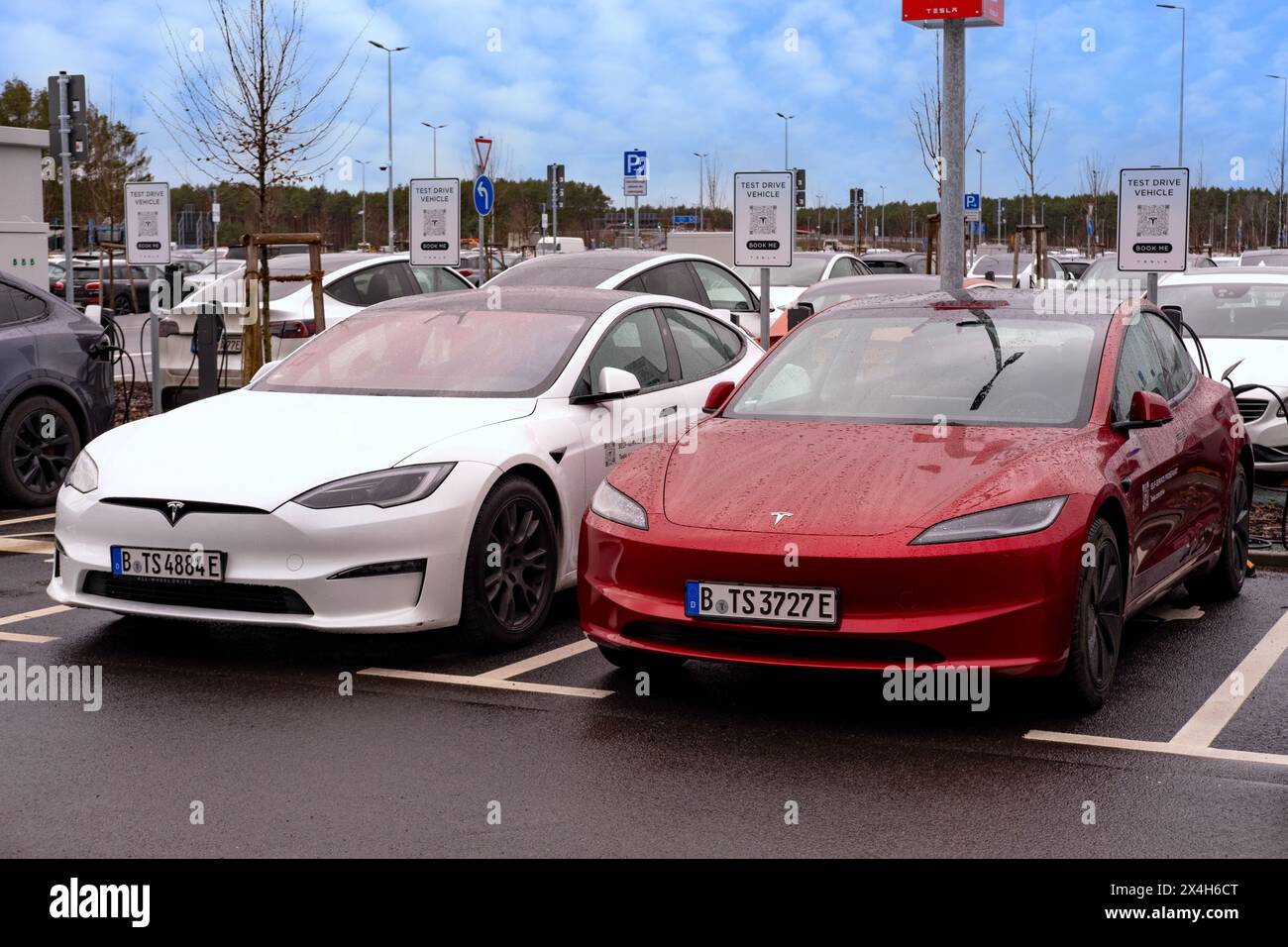 Tesla Model 3 Highland faceliftred vehicles parked in public parking ...