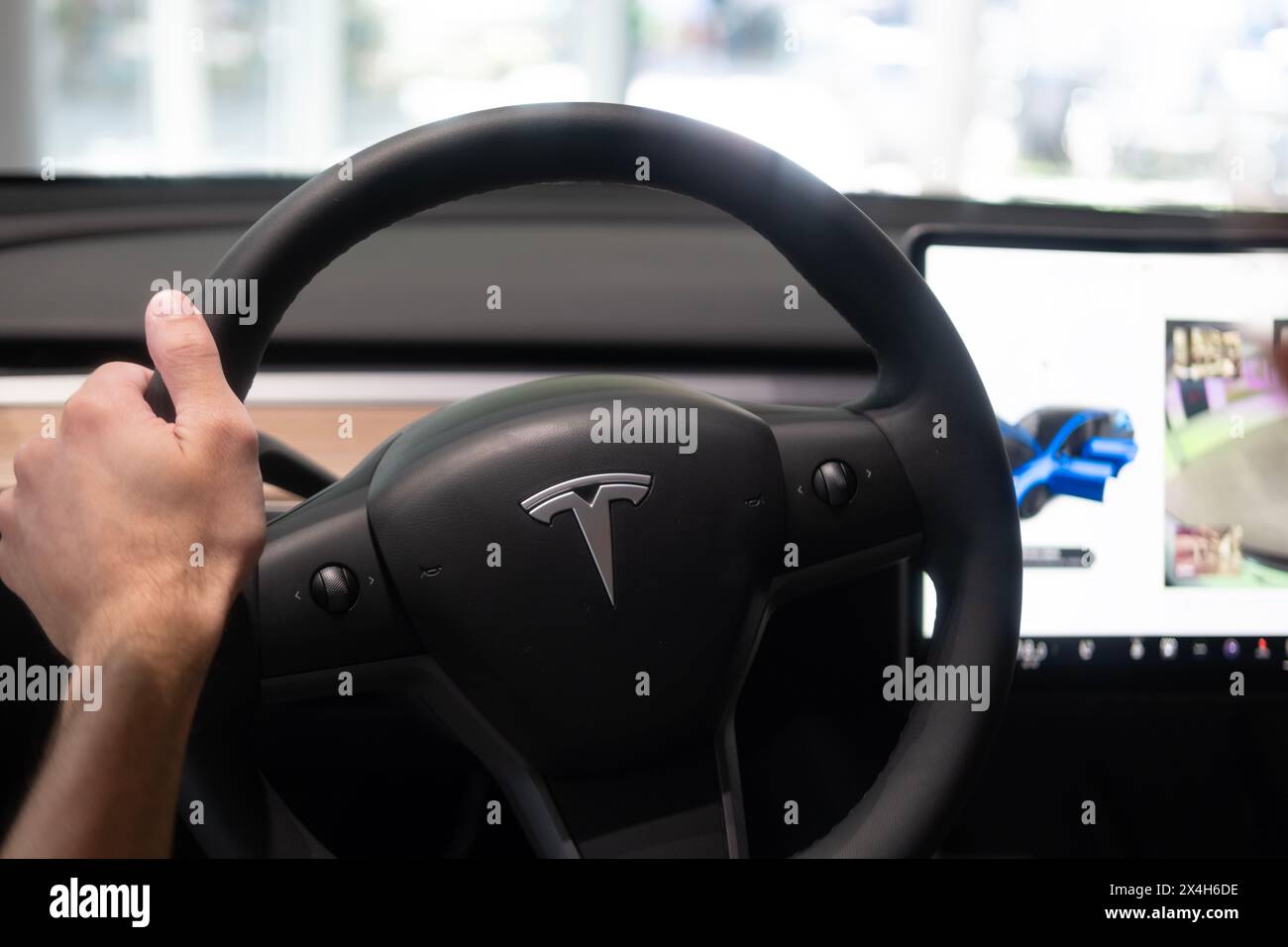 male hand on Driver's column, Behind steering wheel Tesla model Y ...