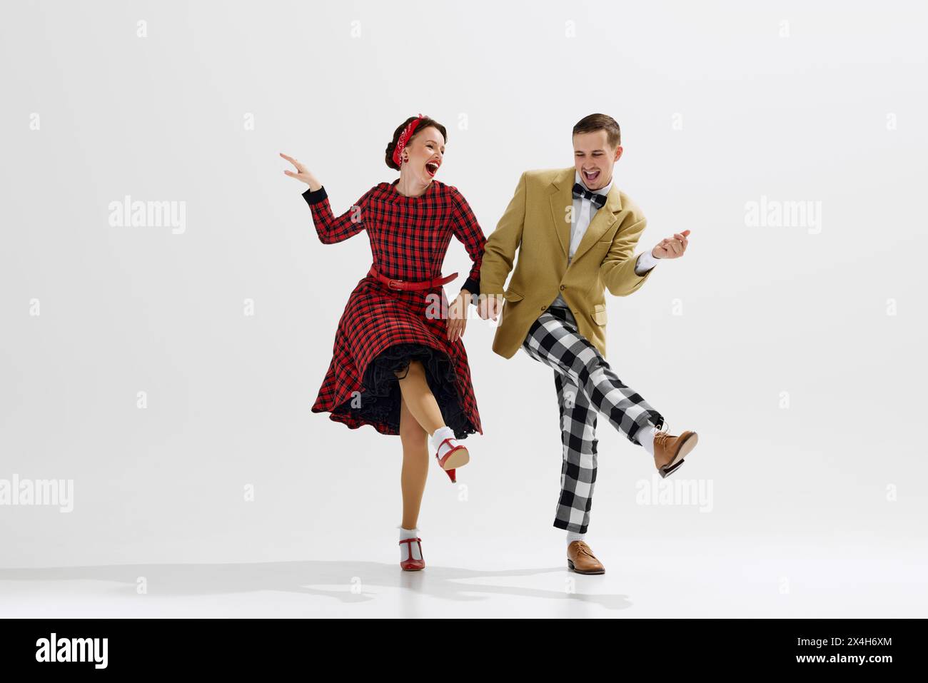 Lovely young couple, man in checkered pants and jacket, woman in red ...