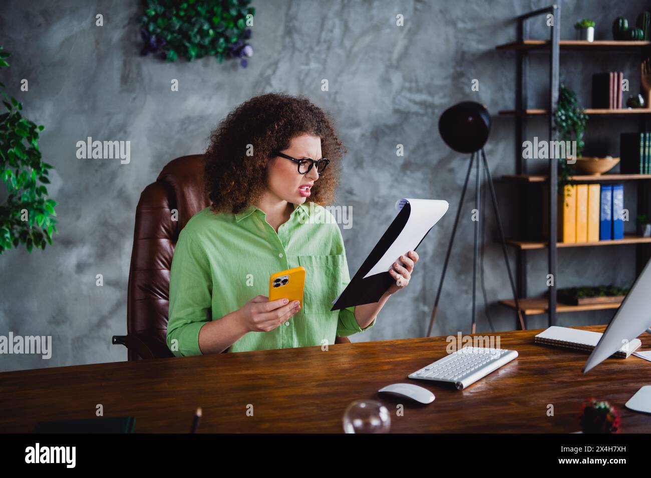 Photo of angry shocked confused woman reading weekly report sitting in ...