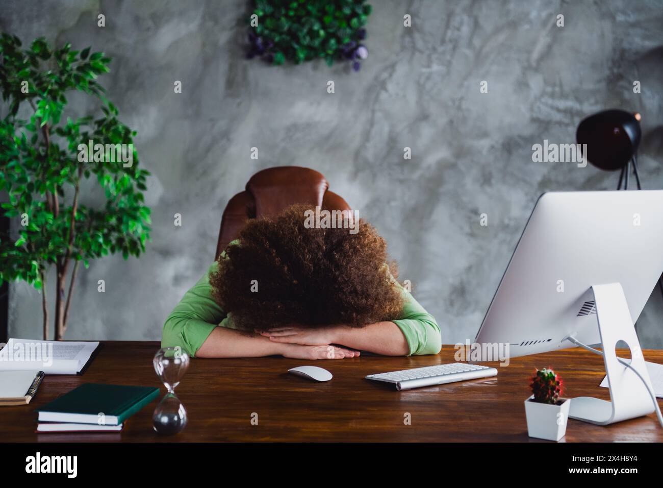 Photo of sleepy exhausted woman sleeping lying table sitting in modern ...