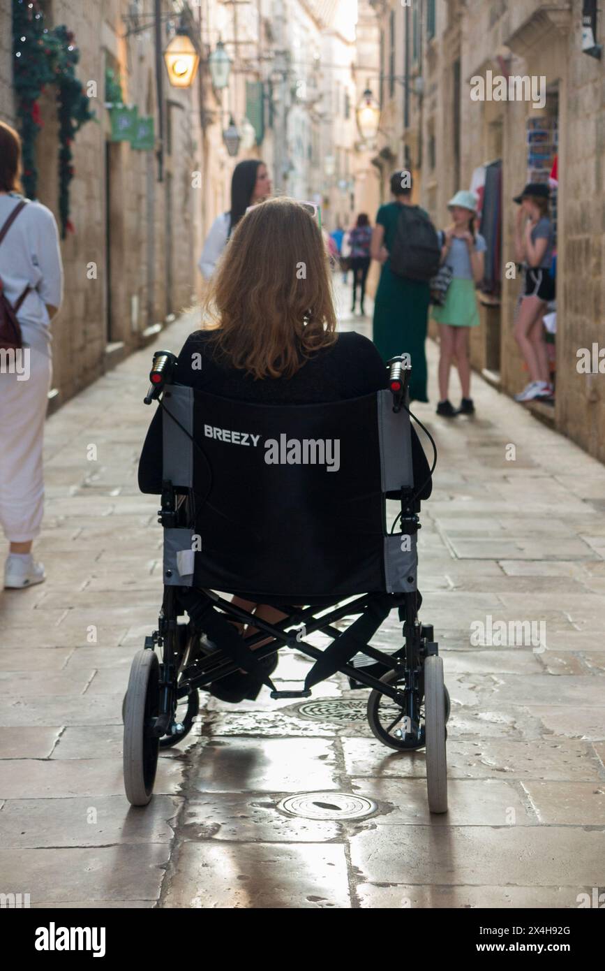 Disabled child teenager tourist / girl kid aged 14 in a wheelchair ...