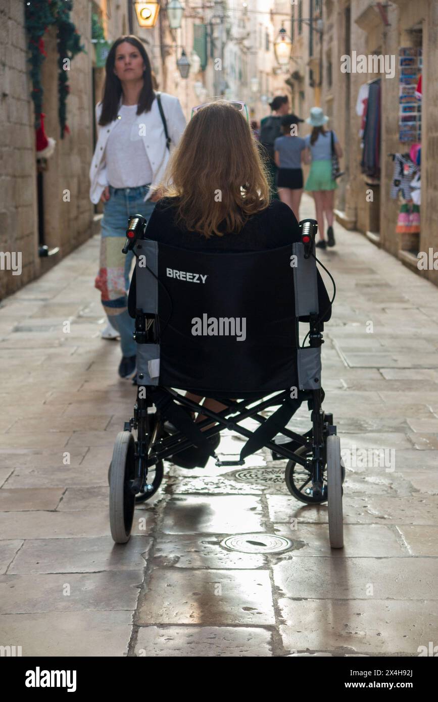 Disabled child teenager tourist / girl kid aged 14 in a wheelchair ...
