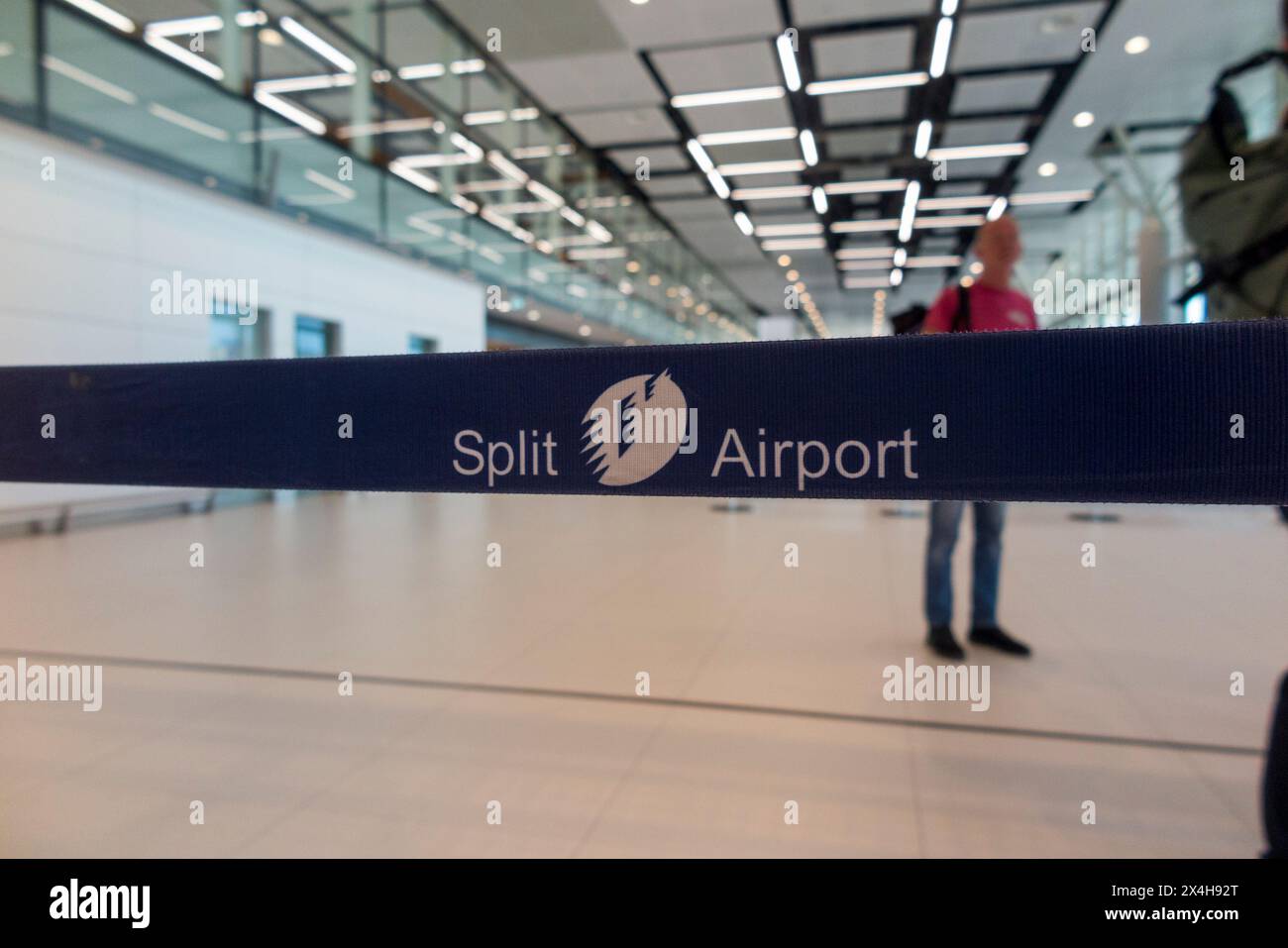 Split Airport branding sign on a portable retractable stretch barrier ...