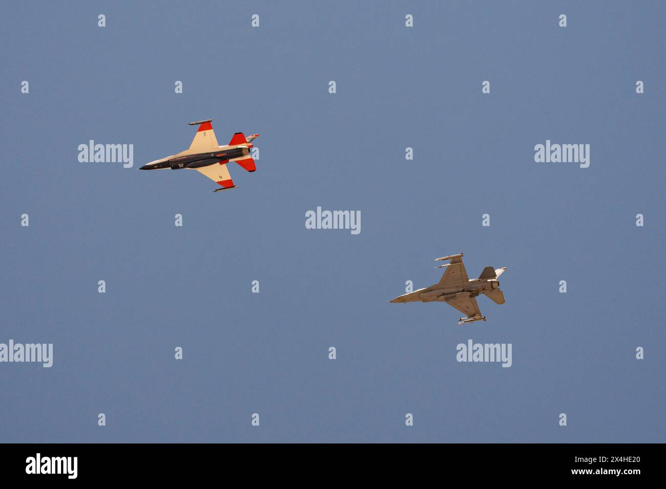 An AI-enabled Air Force F-16 fighter jet, left, flies next to an ...