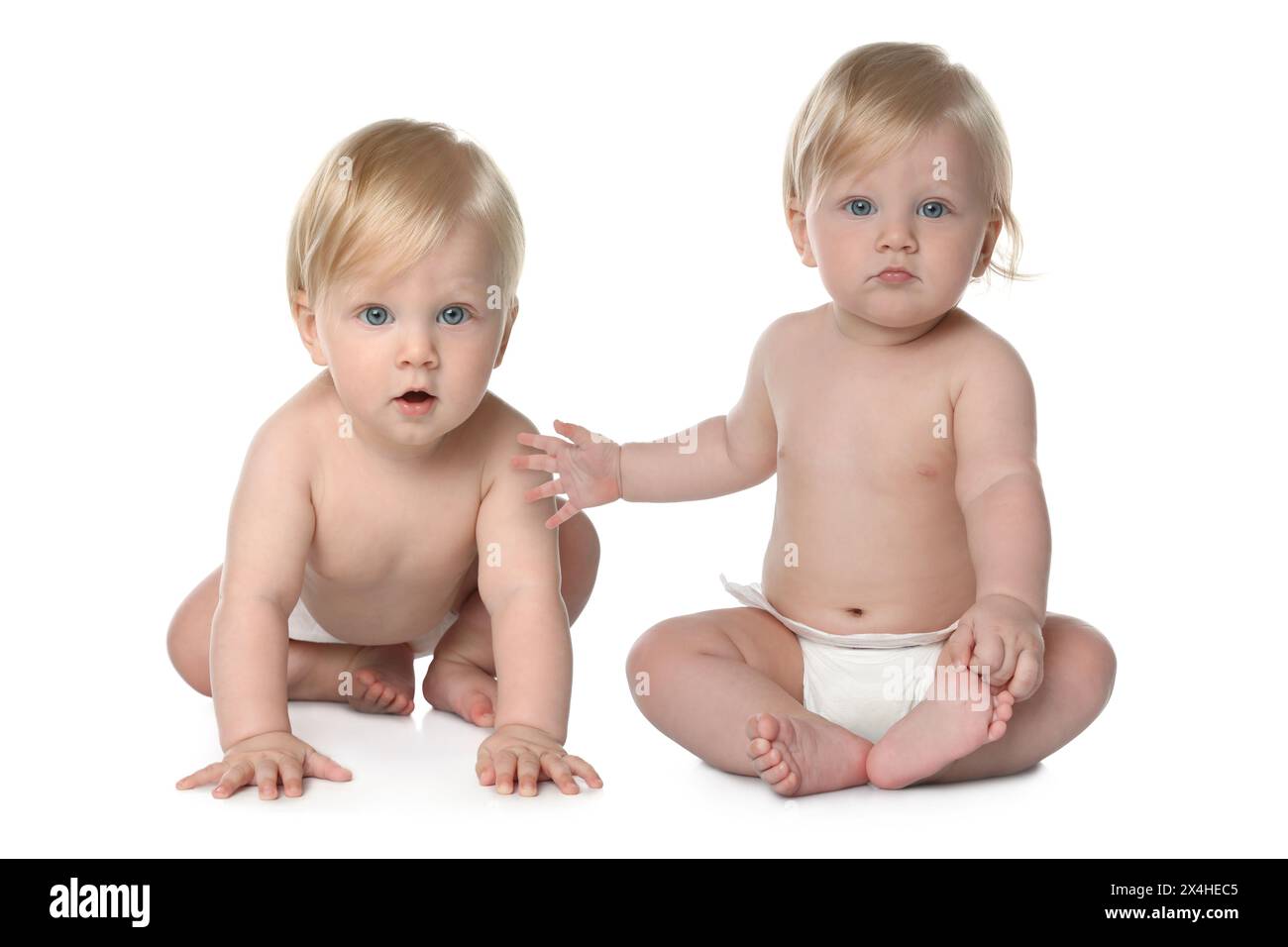 Portrait of cute twin babies on white background Stock Photo - Alamy