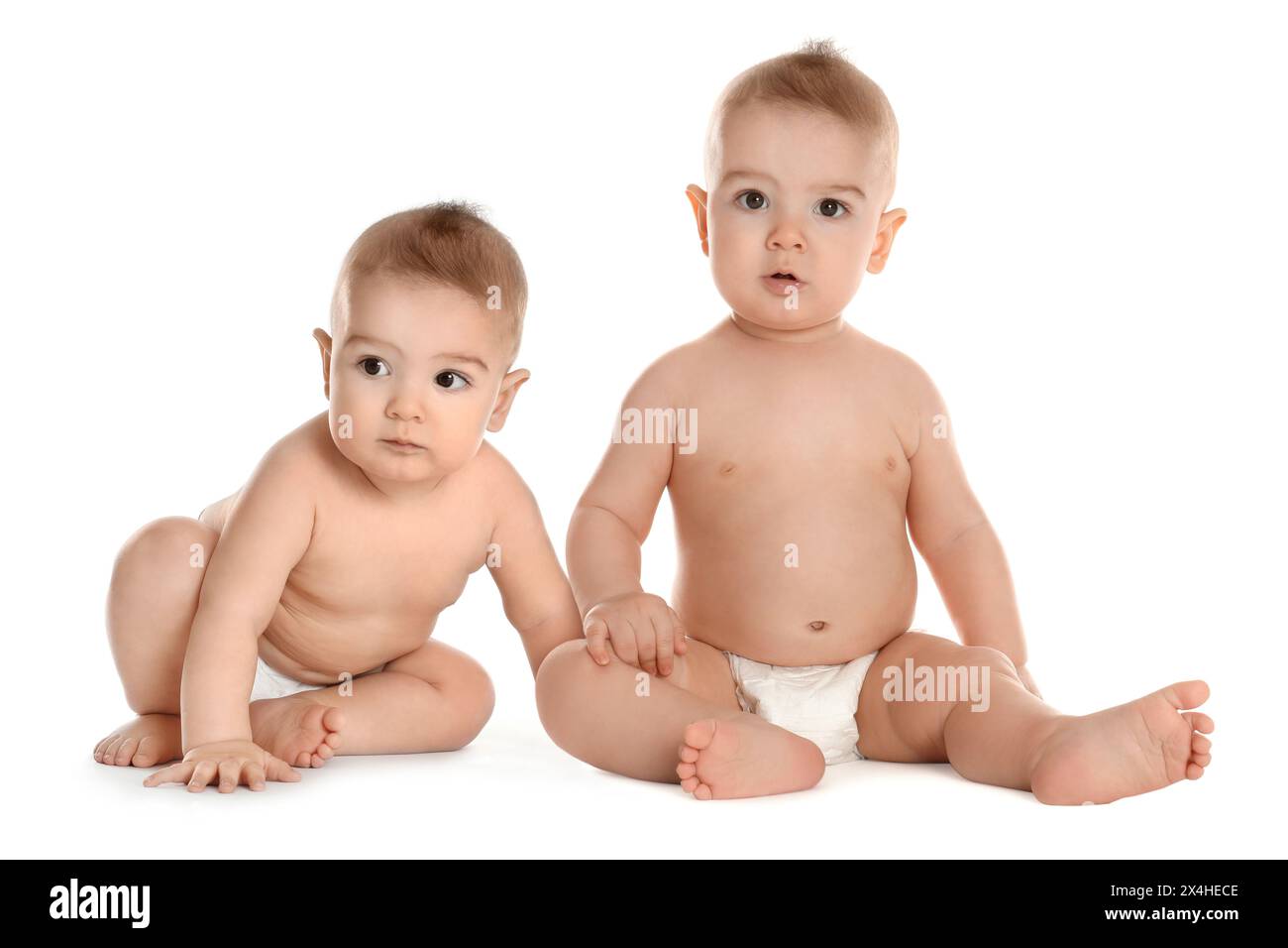 Portrait of cute twin babies on white background Stock Photo - Alamy