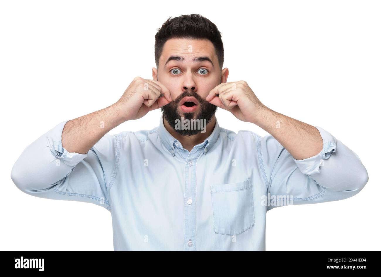 Surprised young man touching mustache on white background Stock Photo ...