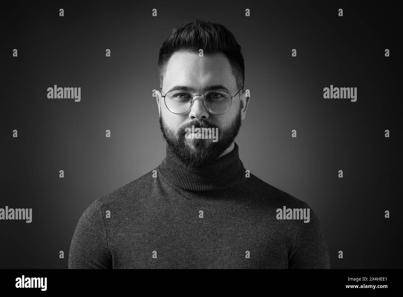 Portrait of handsome bearded man on dark background. Black and white ...