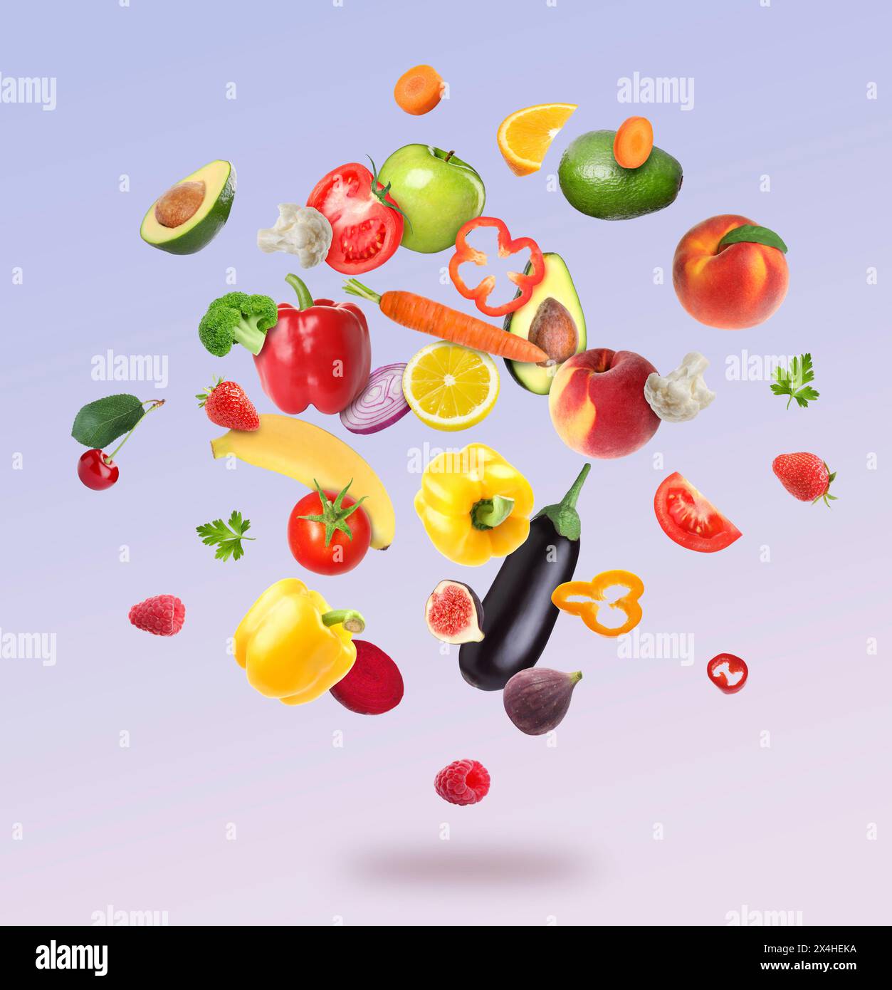 Different fresh fruits and vegetables in air on color gradient ...