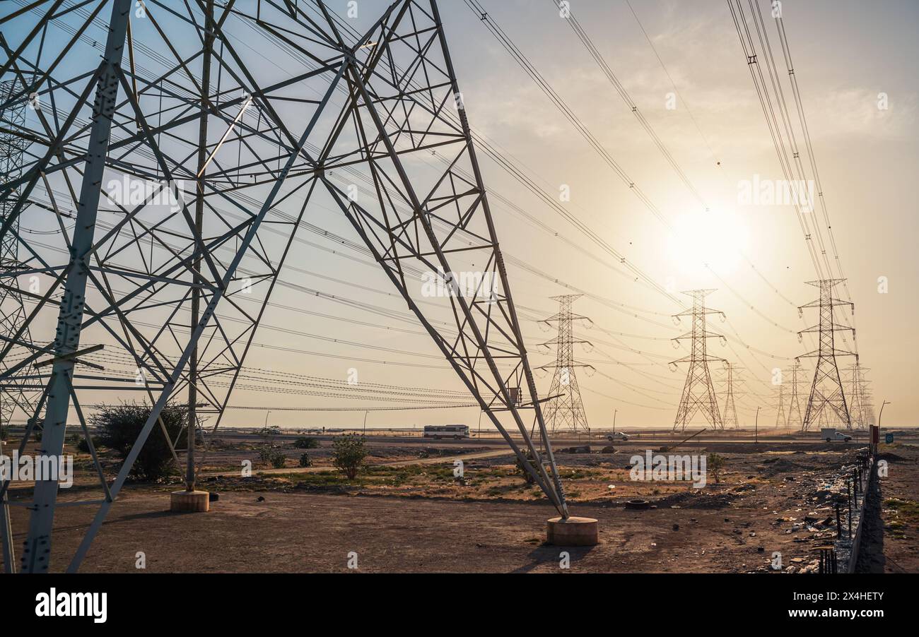 Large tall steel power pylons in rather flat landscape of Saudi Arabia ...