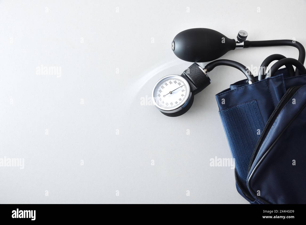 Detail of manual blood pressure monitor with blue cuff isolated on ...