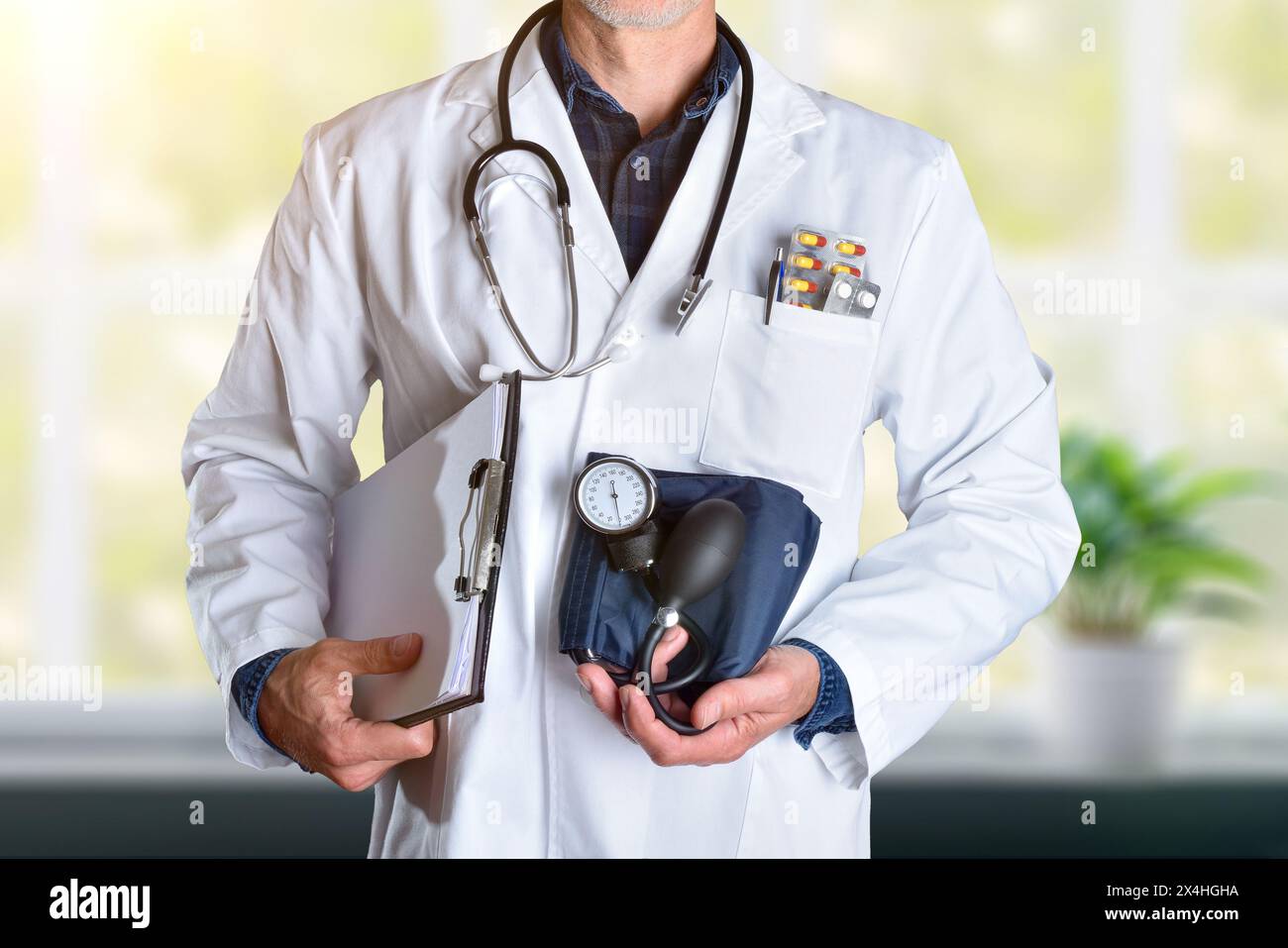 Detail doctor showing blood pressure monitor dressed in white coat with ...